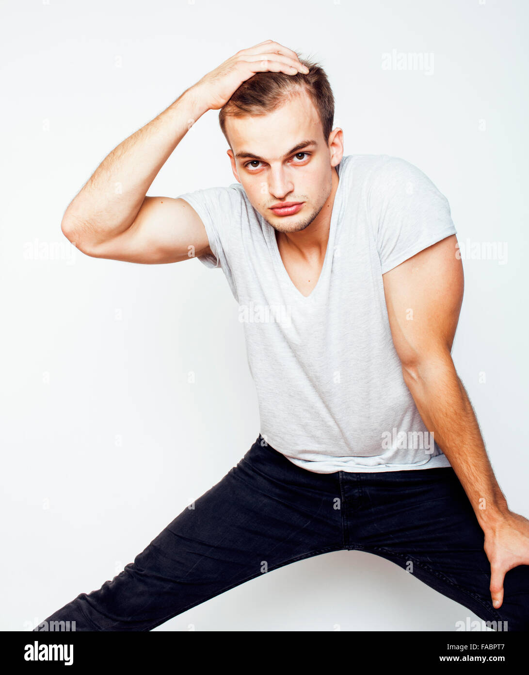 young handsome man on white background gesturing, pointing, posing ...