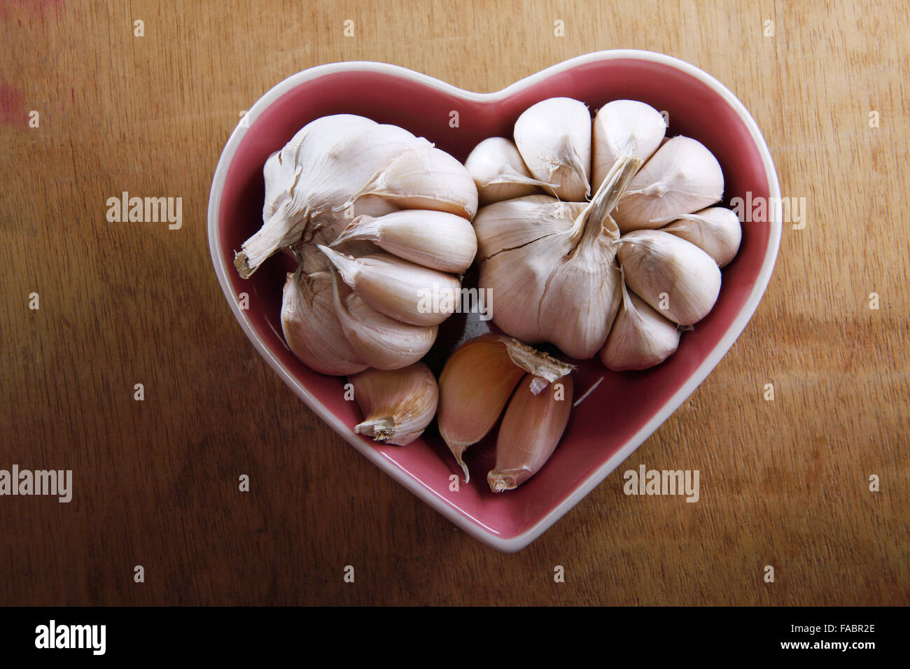 white garlic in the heart shaped bowl Stock Photo - Alamy