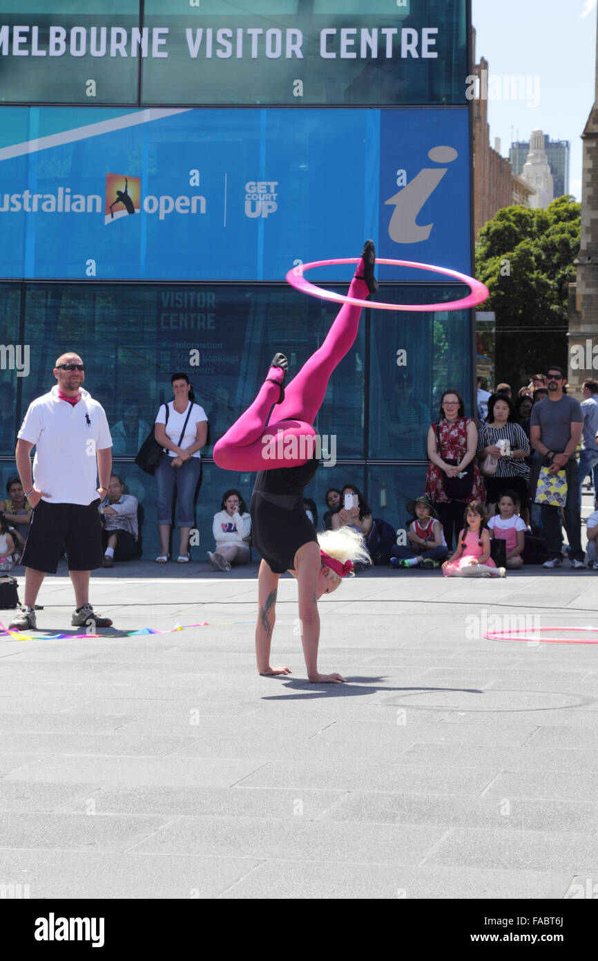 Street performer showing a hula-hoop performance on Federation Square ...