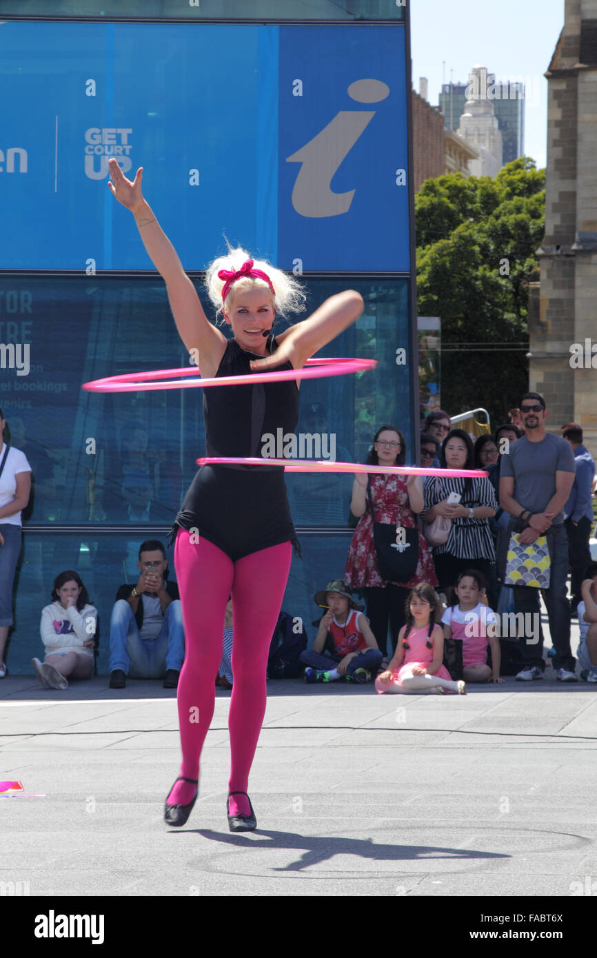 Street performer showing a hula-hoop performance on Federation Square ...
