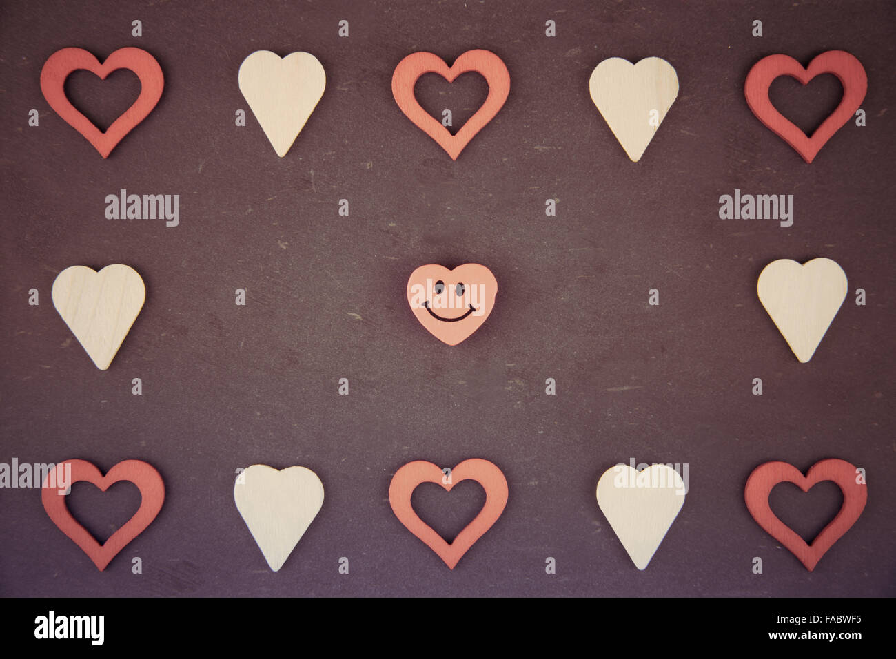 Heart shapes symbols and smiling emoticon isolated on black, vintage ...