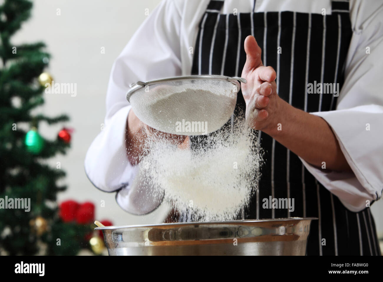 caster sugar sifting through a sieve for a baking Stock Photo - Alamy