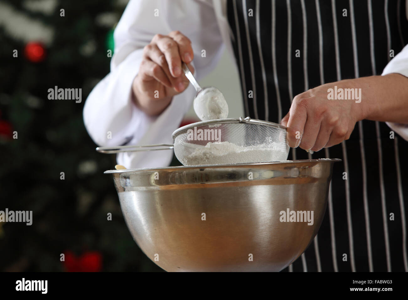 caster sugar sifting through a sieve for a baking Stock Photo - Alamy