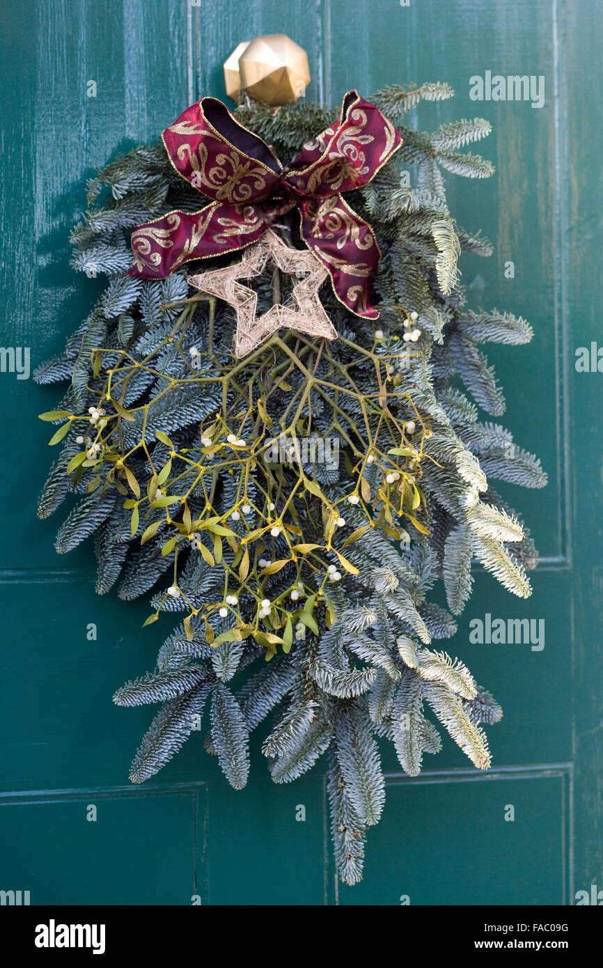 A Mistletoe Christmas Wreath on a front Door Stock Photo - Alamy