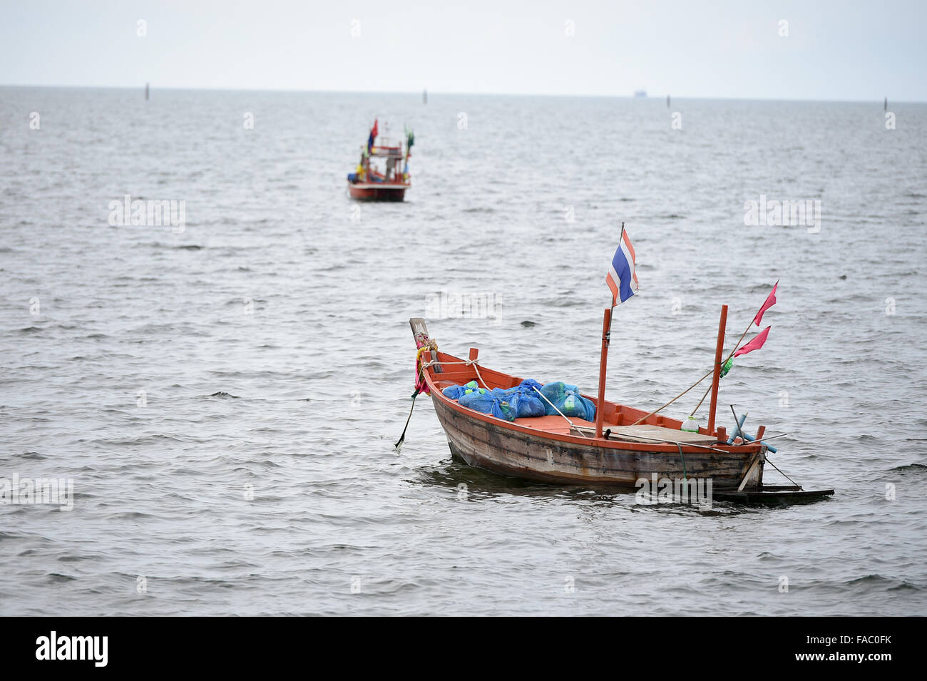 A small boat floating in the sea Stock Photo - Alamy