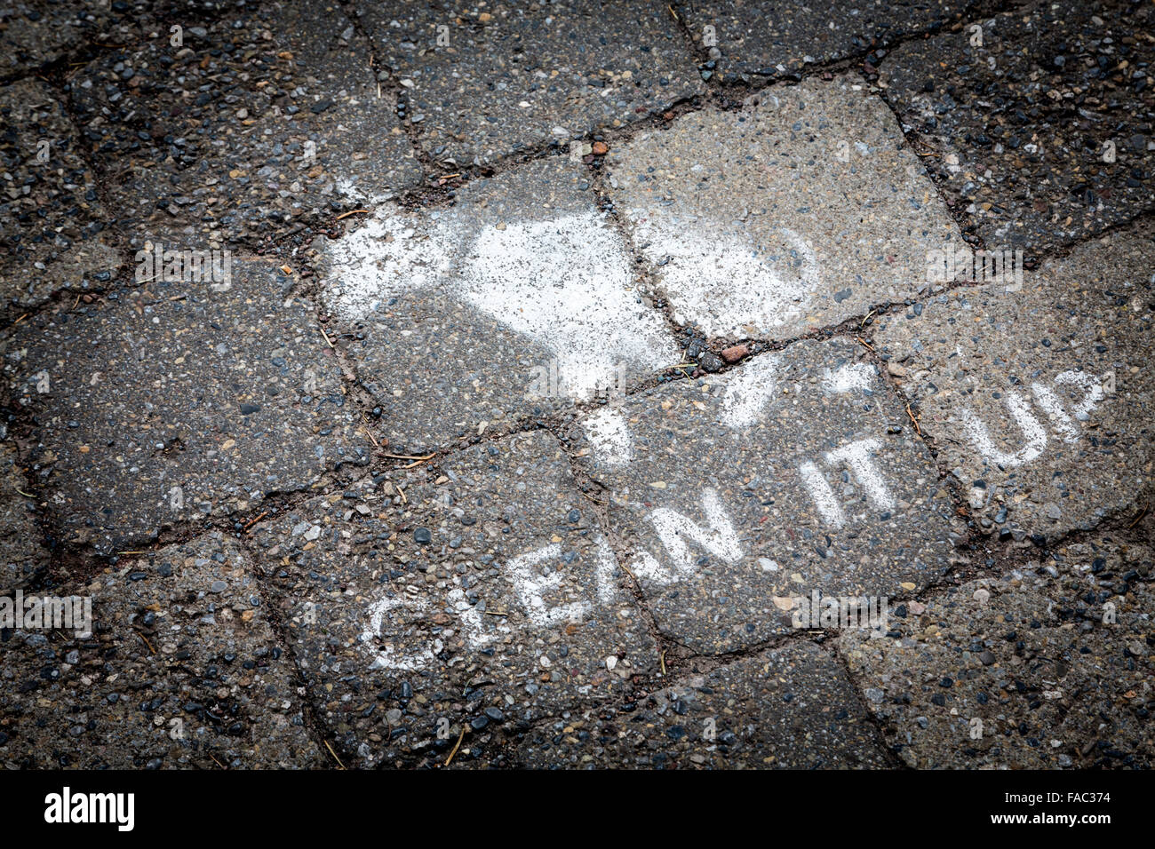 Clean it up caption on pavement Stock Photo - Alamy
