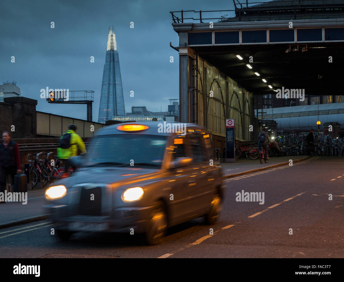 A taxi leaves Waterloo station in london with the Shard skyscraper ...