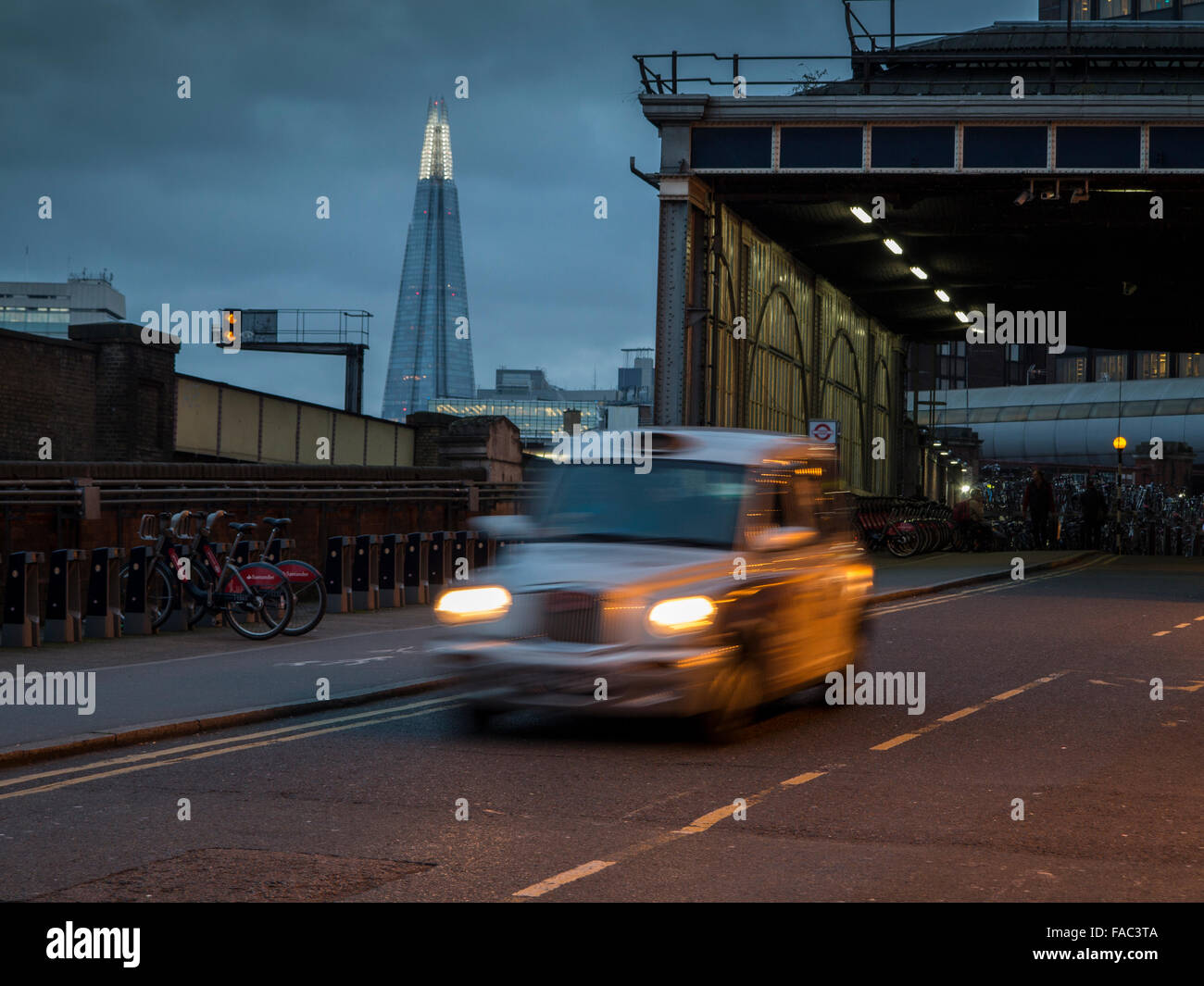 A taxi leaves Waterloo station in london with the Shard skyscraper ...