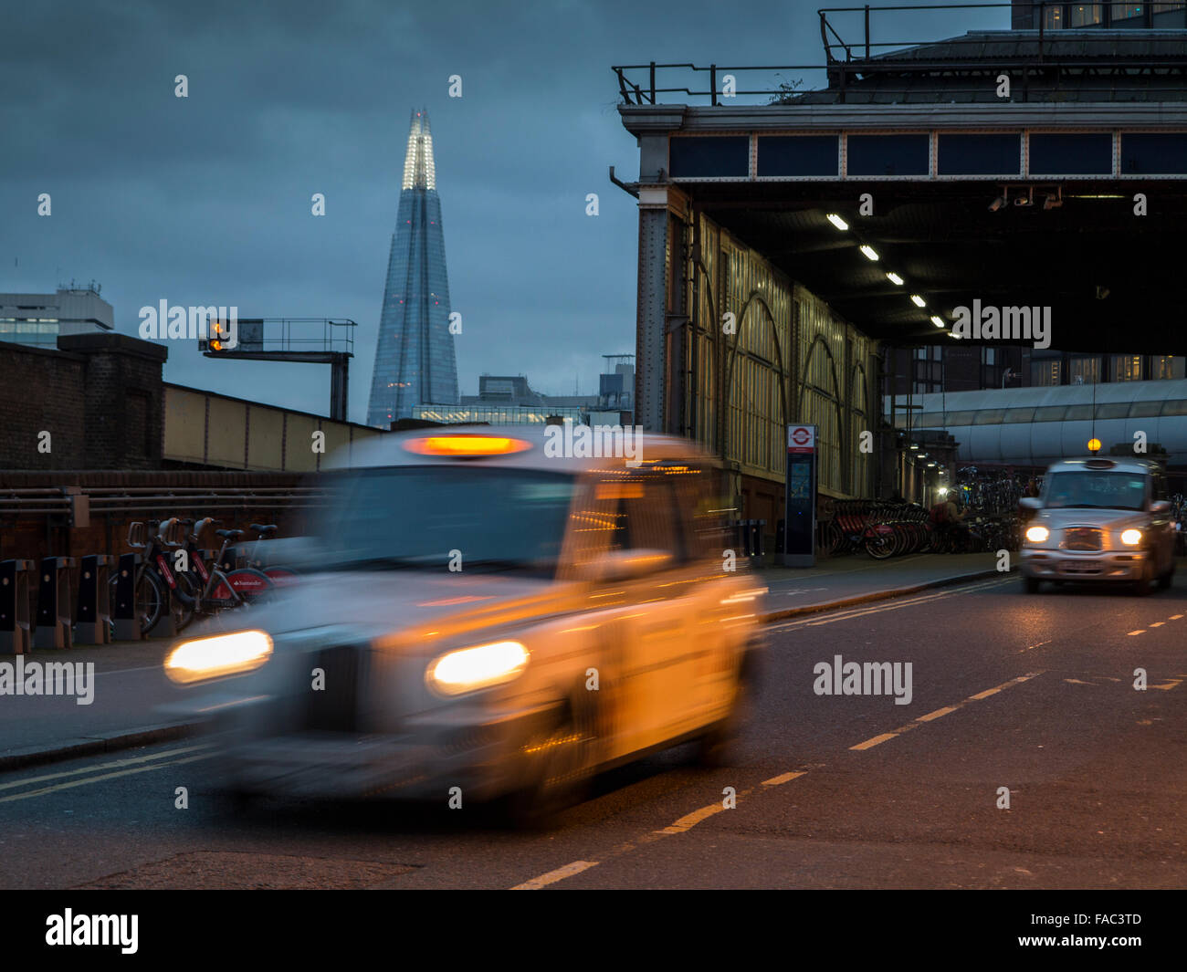A taxi leaves Waterloo station in london with the Shard skyscraper ...