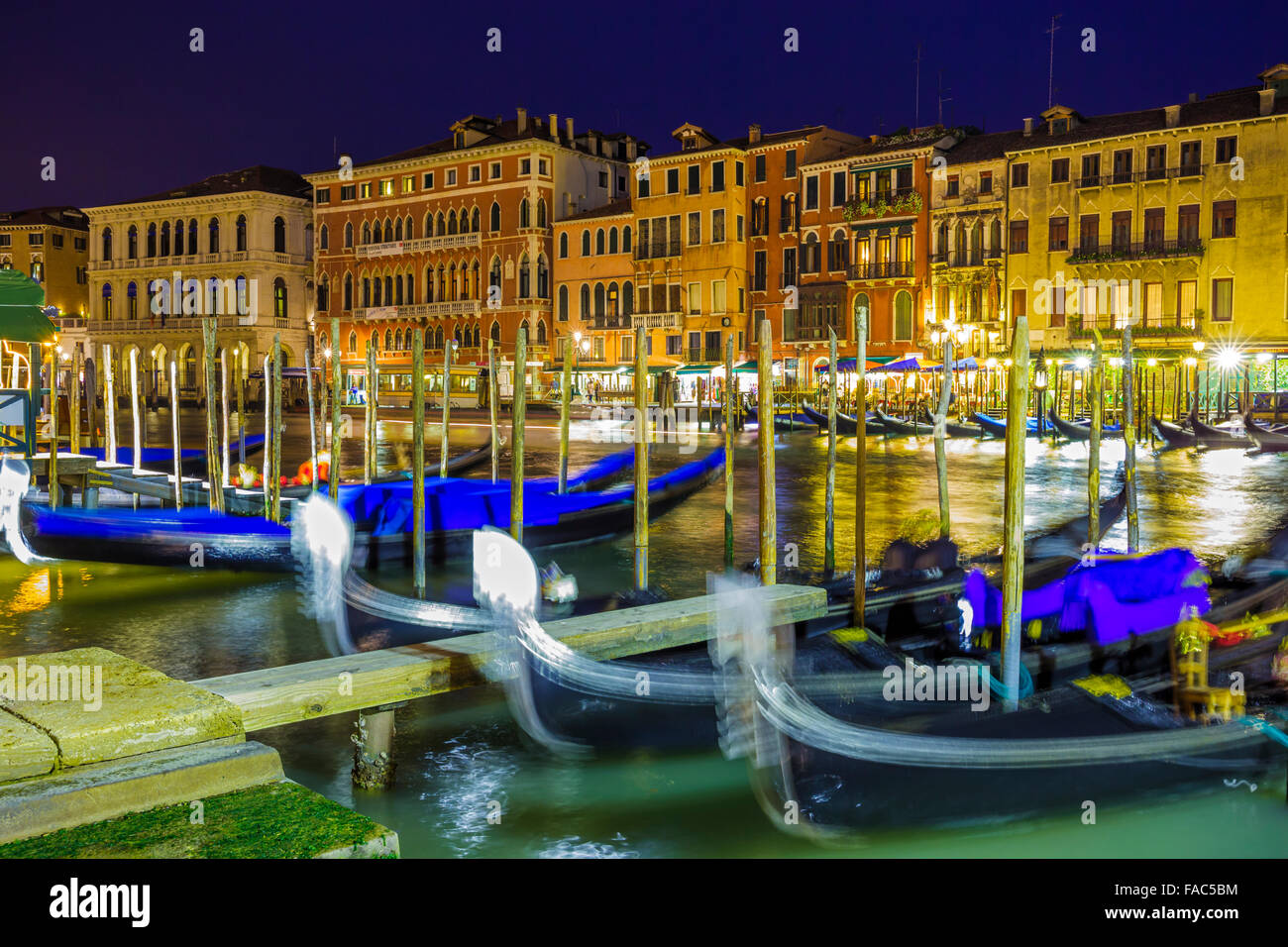 gondolas moored on the Grand Canal at night, Venice Stock Photo - Alamy