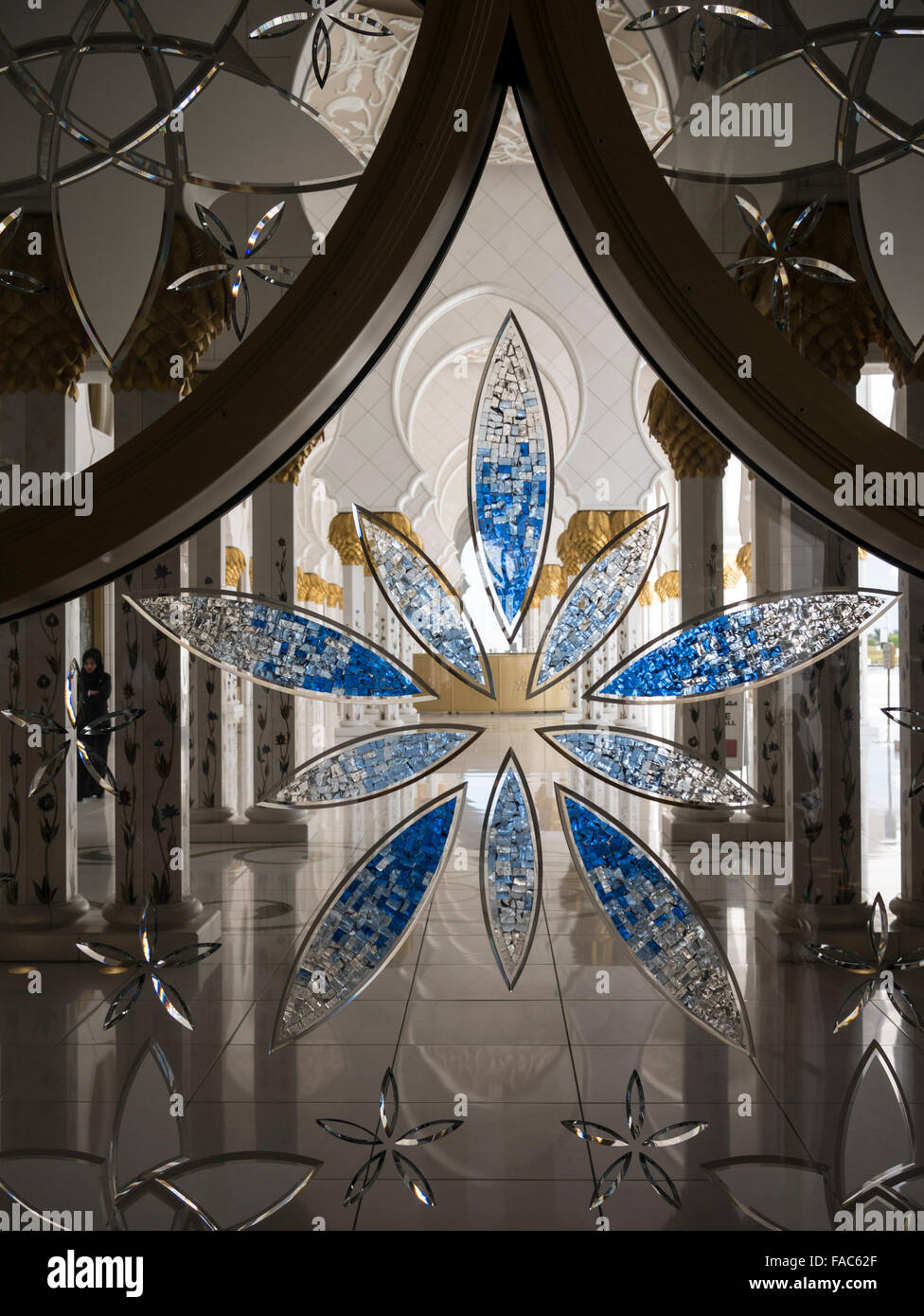 Tourists walking past an ornate wall in Sheikh Zayed Grand Mosque ...