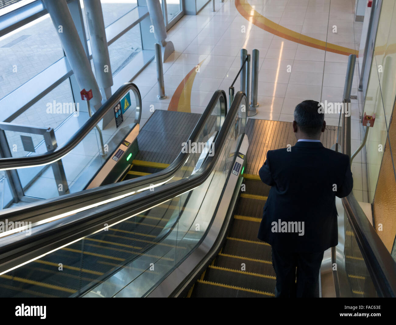 Business man dressed in suit in an escalator Stock Photo - Alamy