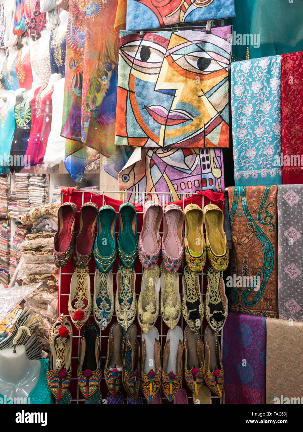 Dubai textile souk (market). Close up of sandals, shawls and colorful ...