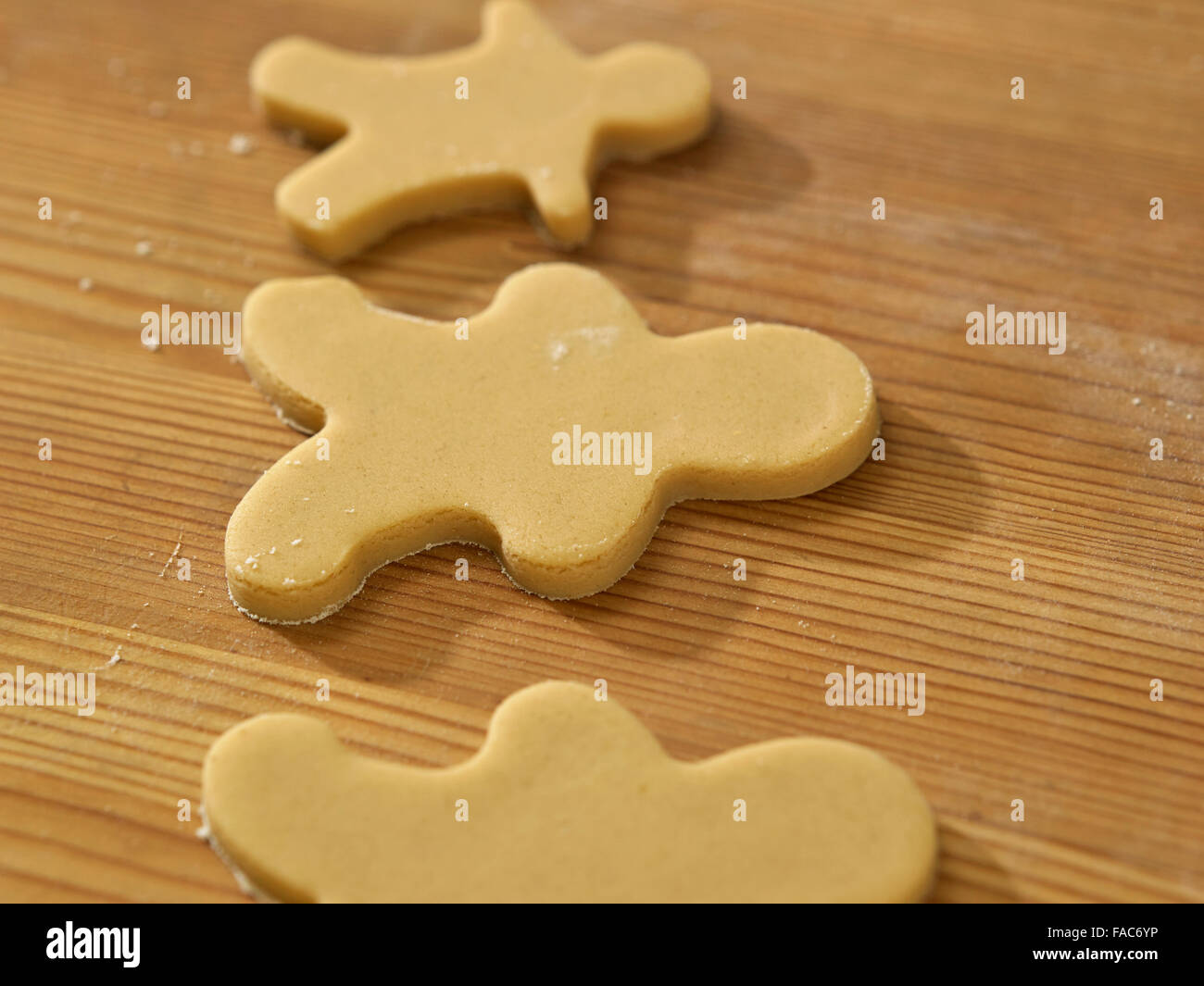 Uncook Plain gingerbread man on table Stock Photo - Alamy