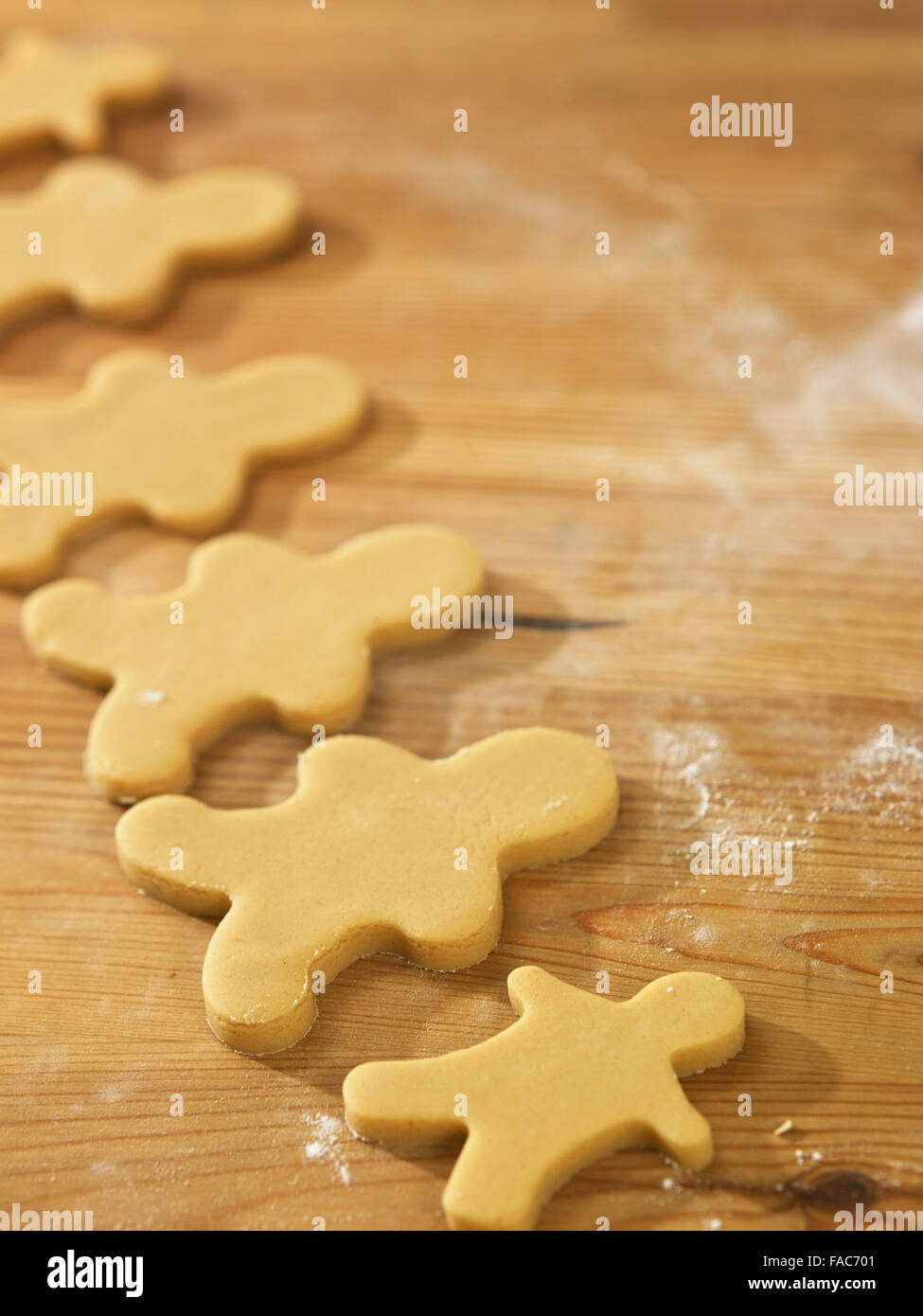 Uncook Plain gingerbread man on table Stock Photo - Alamy