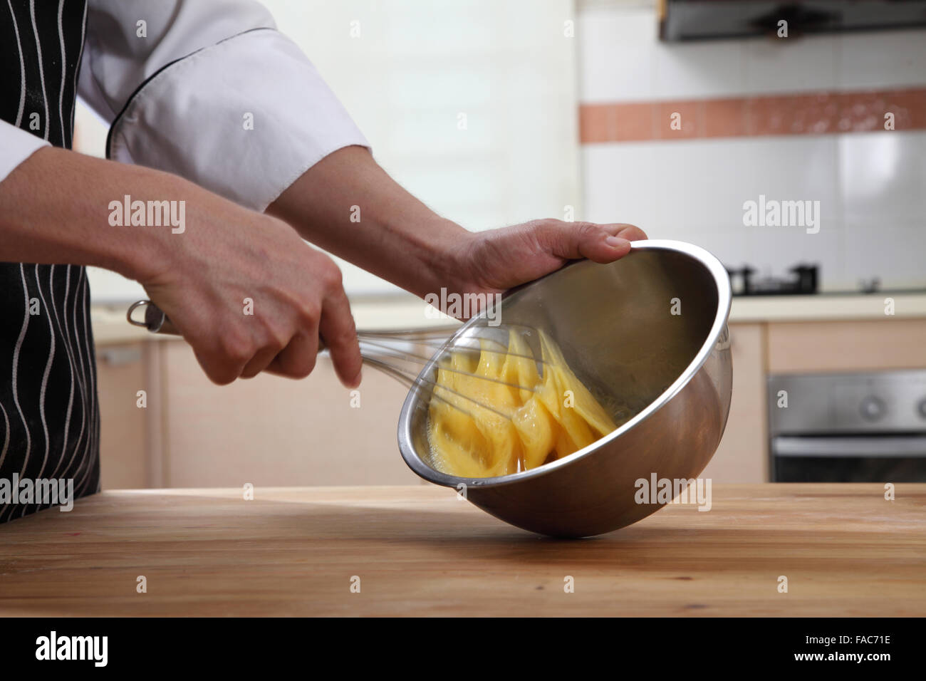 hands beating eggs in a bowl Stock Photo - Alamy