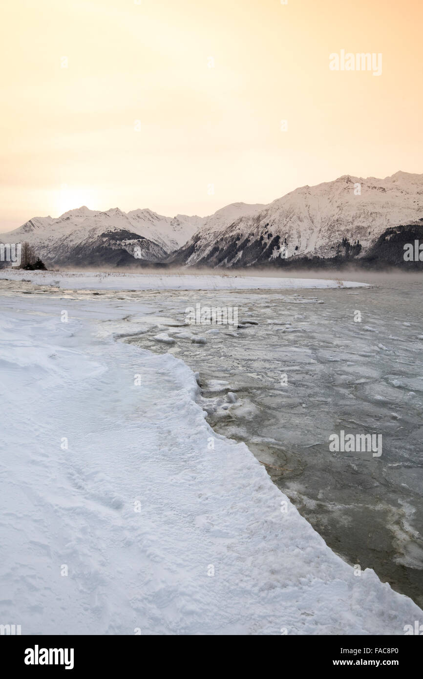 Icy beach near Haines Alaska with frozen water and sunset colors over ...