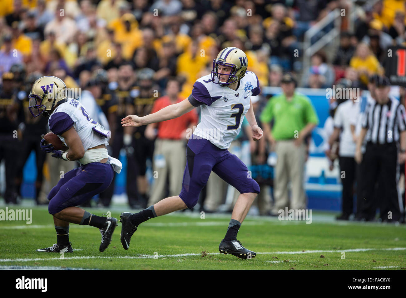 Dallas, Texas, USA. 26th Dec, 2015. Jake Browning (3) hands off the ...
