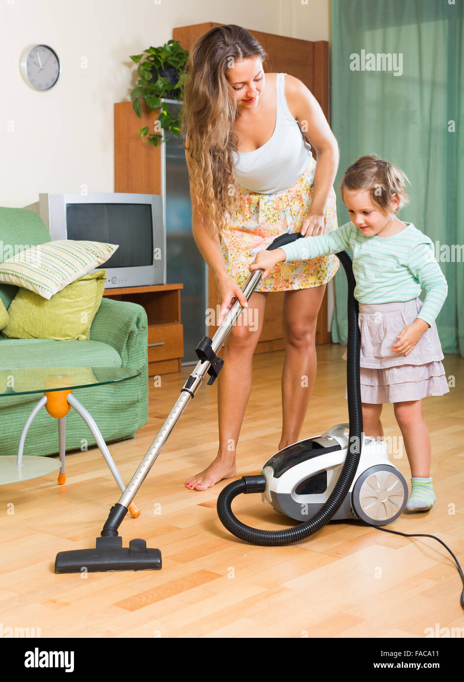 Happy mother and young daughter are doing house cleaning Stock Photo ...