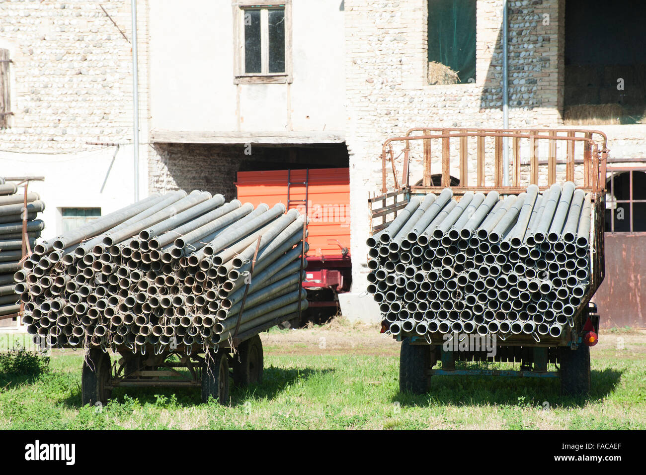 Farm wagons loaded with metal rigid pipes for irrigation Stock Photo ...
