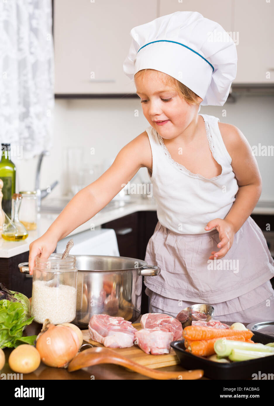 Little child cooking soup with vegetables at kitchen Stock Photo - Alamy