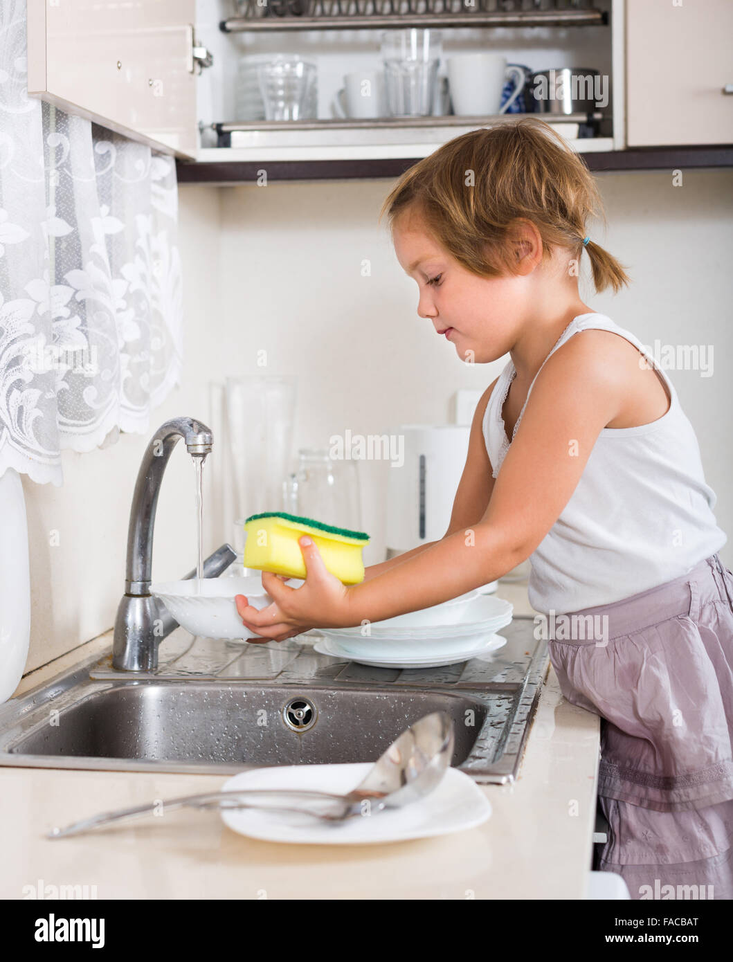 Active little child washing dishes at domestic kitchen Stock Photo - Alamy