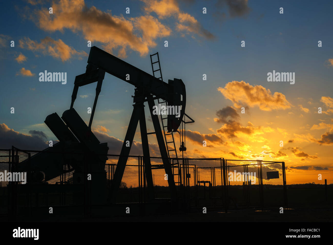 oil rig silhouette pumping at evening on cloudy sky background Stock ...