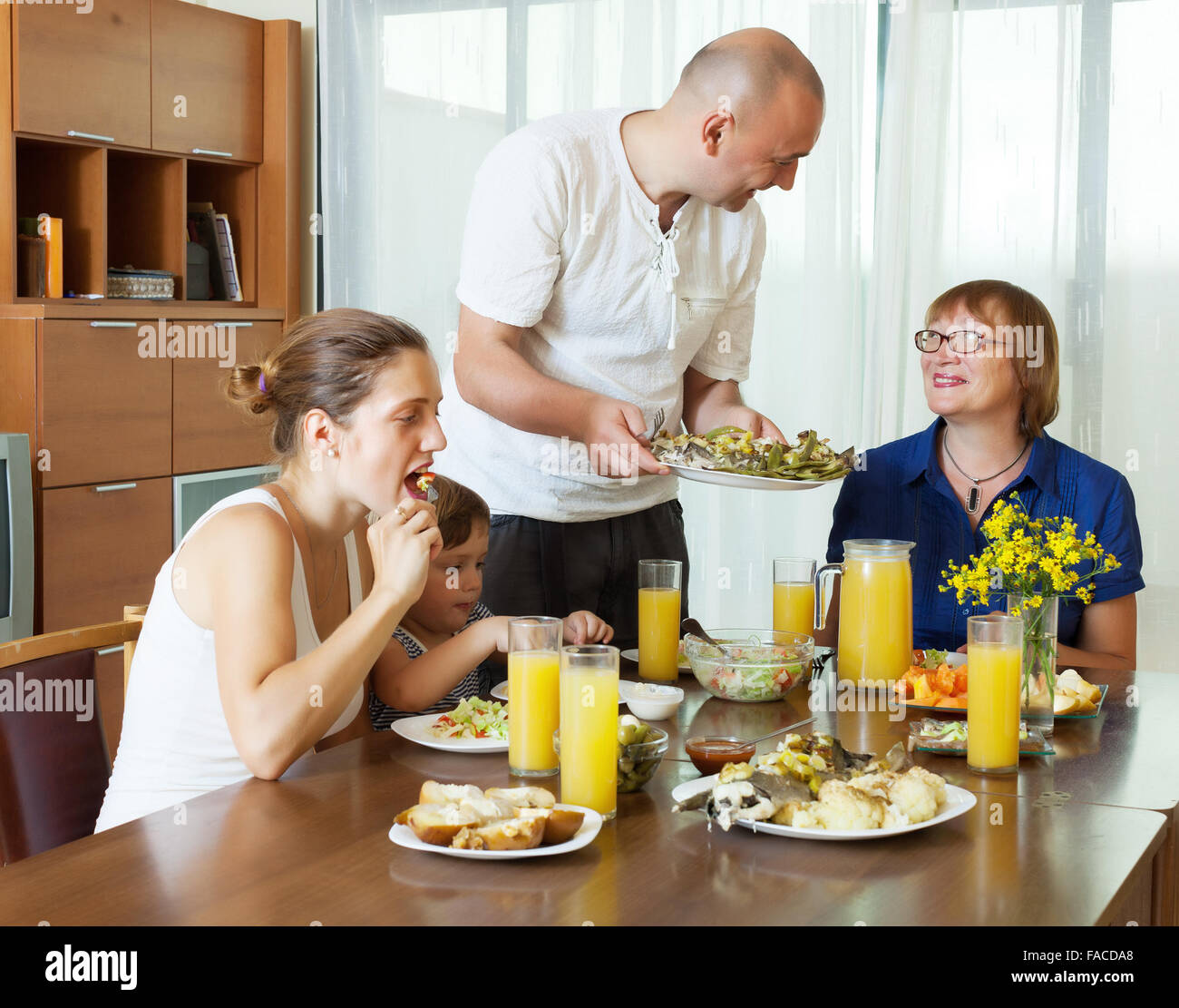 Mature woman eating fish and vegetables hi-res stock photography and ...
