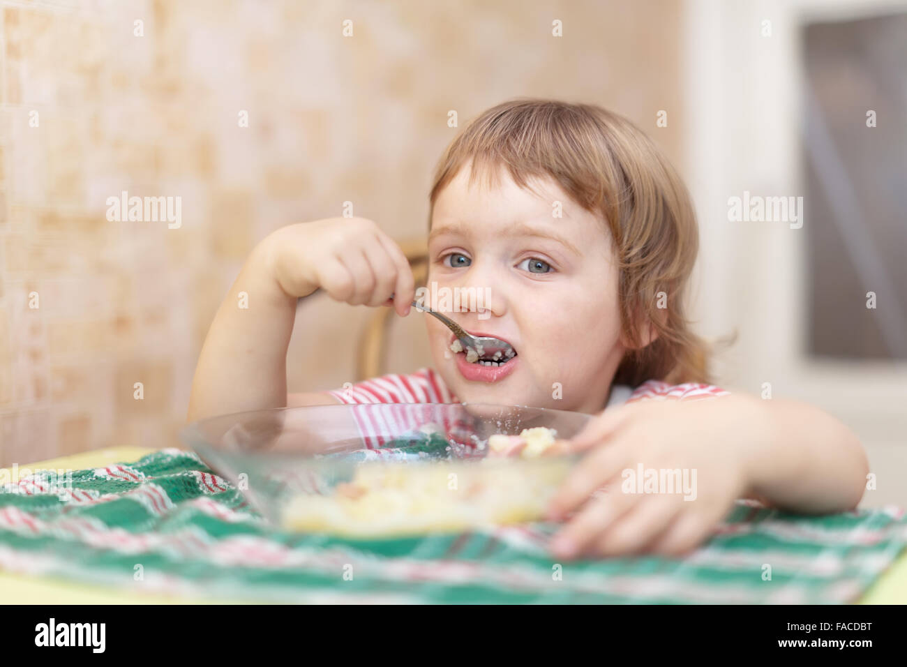 child eats with spoon in home Stock Photo - Alamy