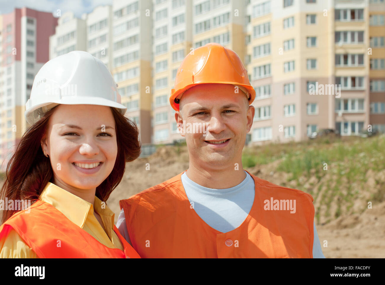 two happy builders in hardhat works on the building site Stock Photo ...