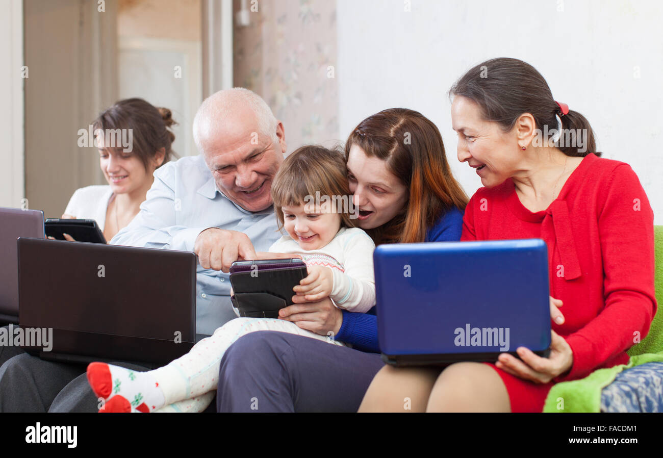 Happy family uses electronic devices in home Stock Photo - Alamy