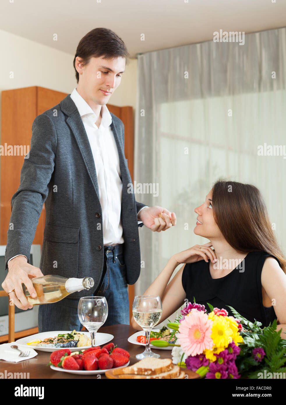 Man and woman having romantic dinner in home Stock Photo - Alamy