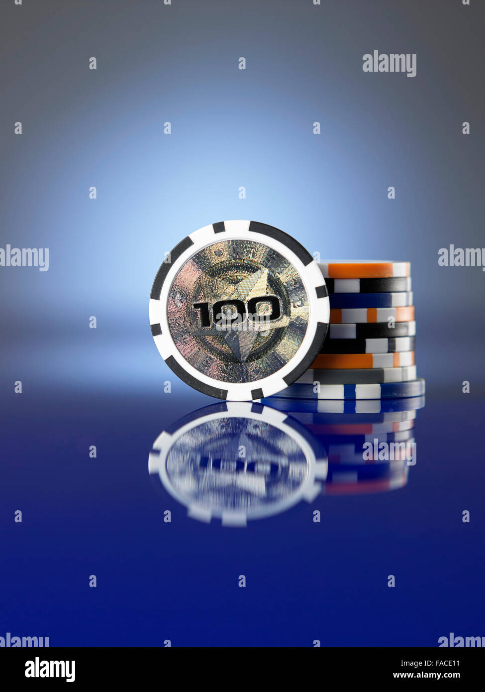 hundred dollar chips on the blue background Stock Photo - Alamy