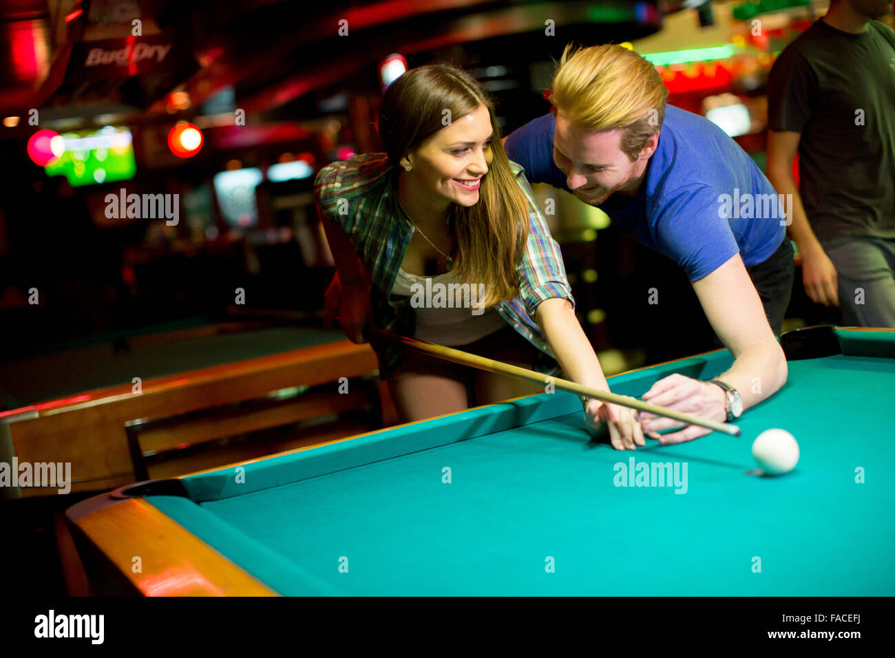 Young people playing pool Stock Photo - Alamy