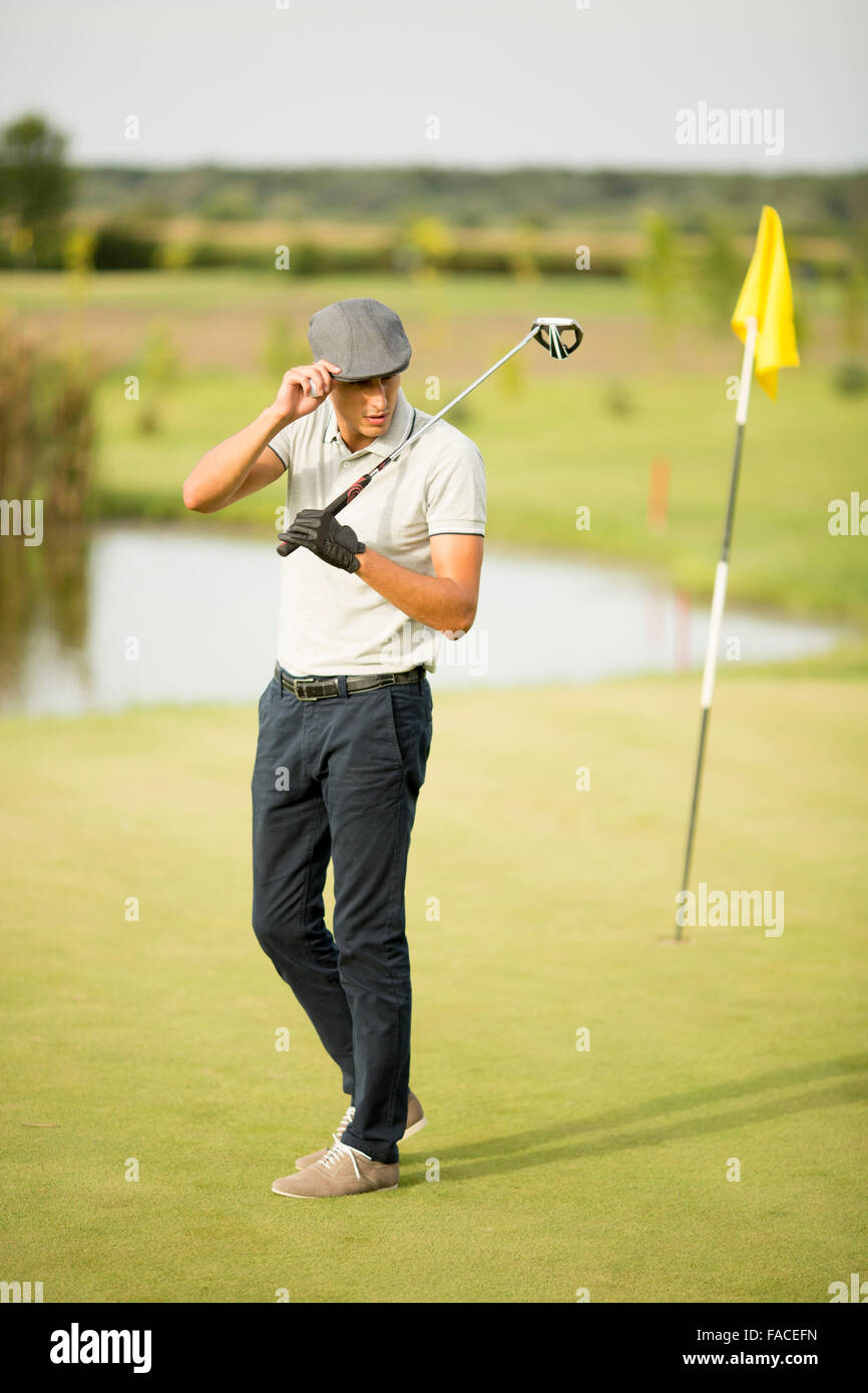 Young man playing golf Stock Photo - Alamy