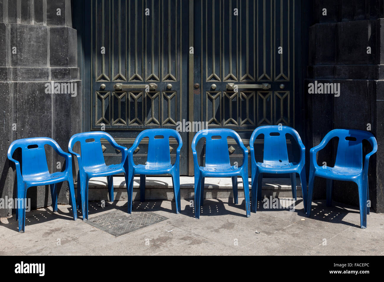 Six blue plastic chairs in a semi-circle, Santiago de Chile, Chile ...