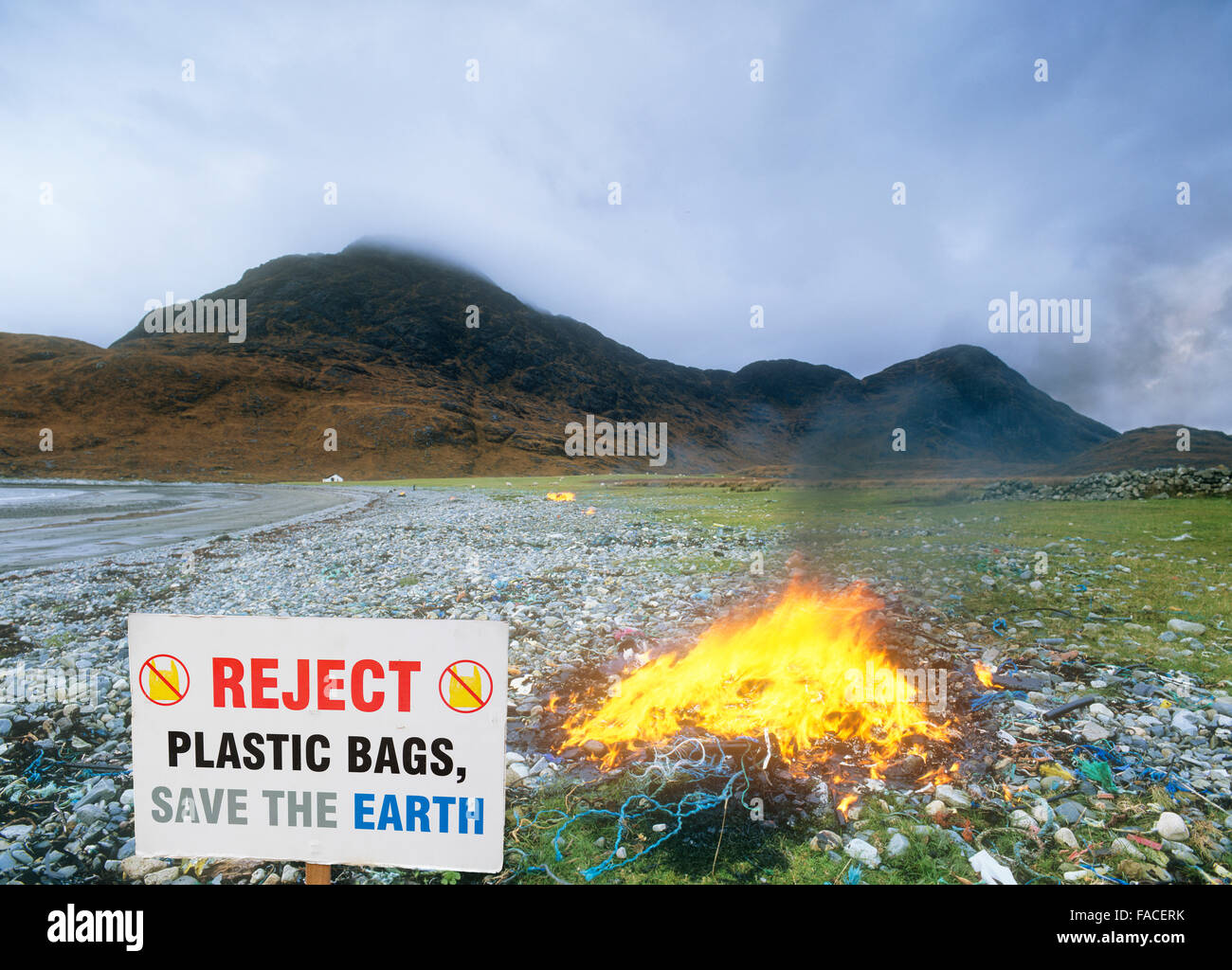 Burning plastic rubbish that was washed up on a beach on the Isle of ...
