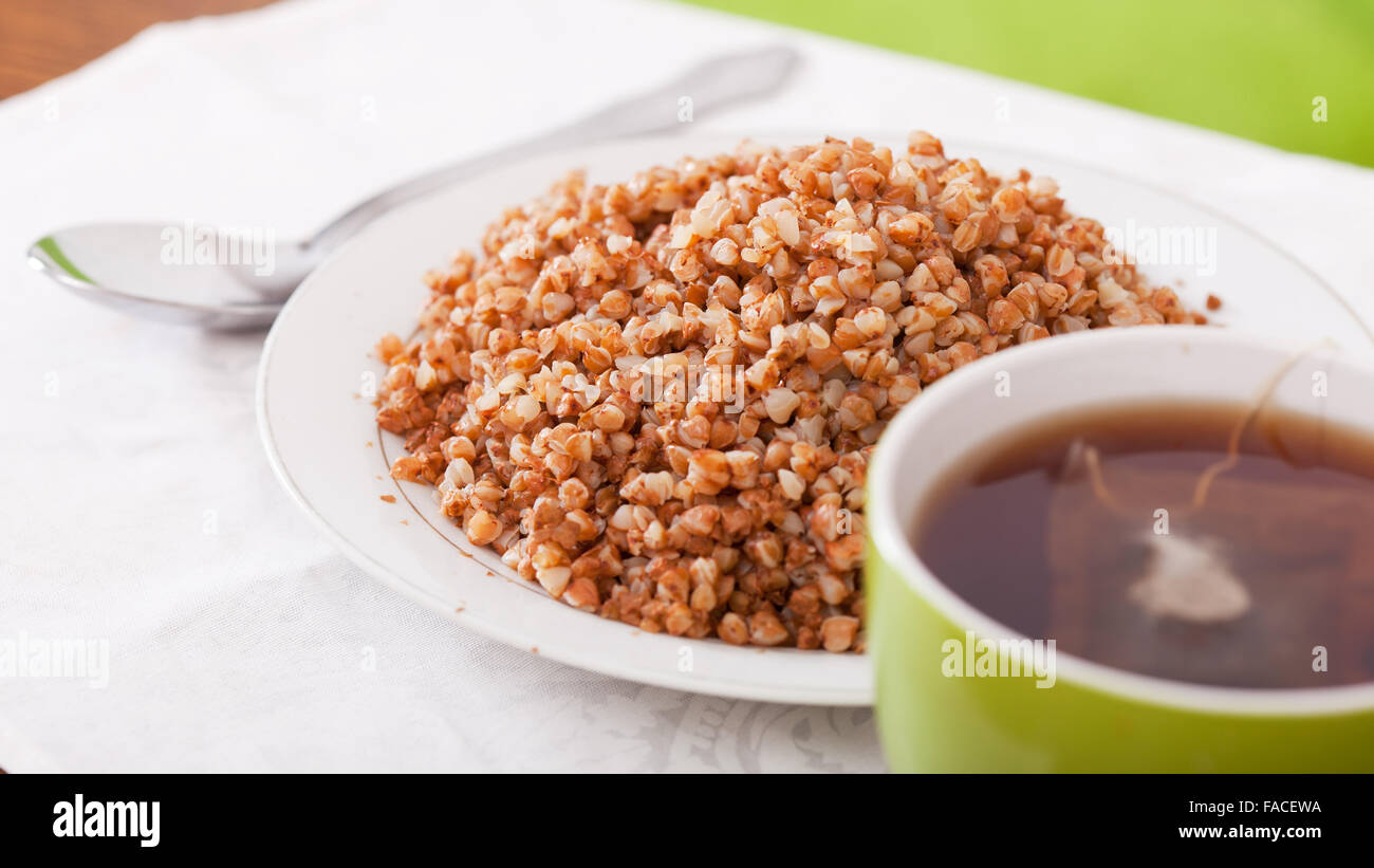 boiled buckwheat porridge in plate with tea at home Stock Photo - Alamy