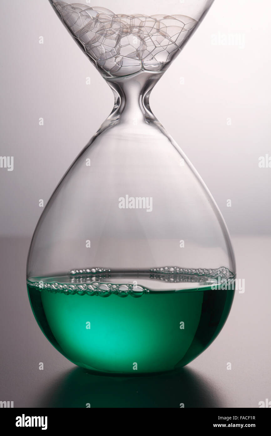 water base hour glass on the gray background Stock Photo - Alamy