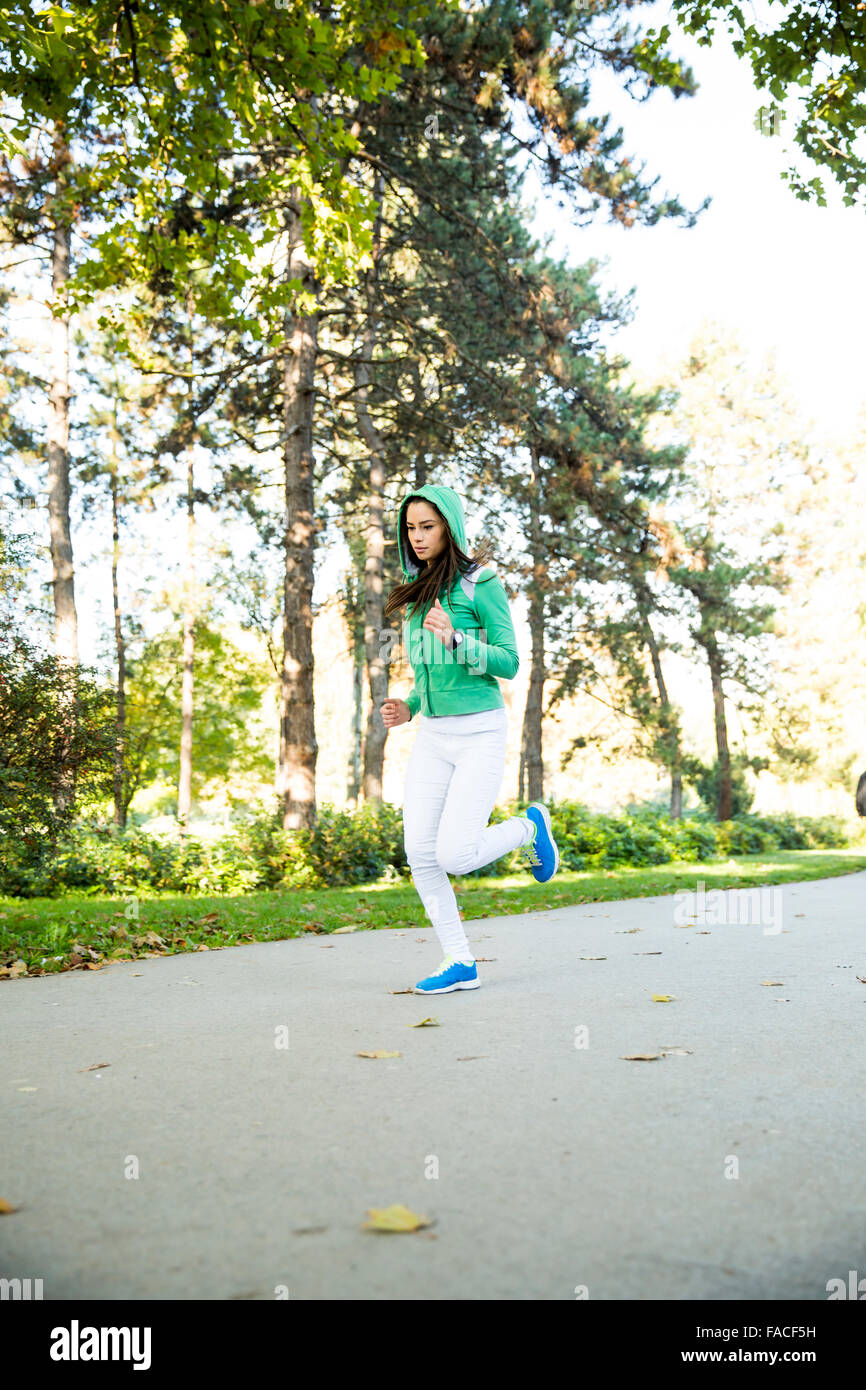 Young woman running in the park Stock Photo - Alamy