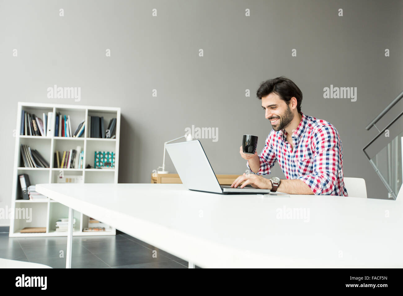 Young man at the office Stock Photo - Alamy
