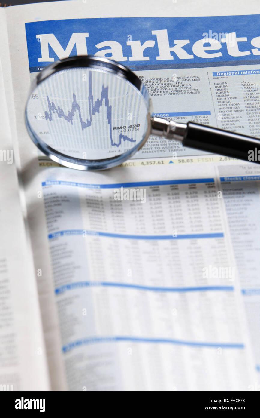 close up on the magnifier glass on financial report Stock Photo - Alamy