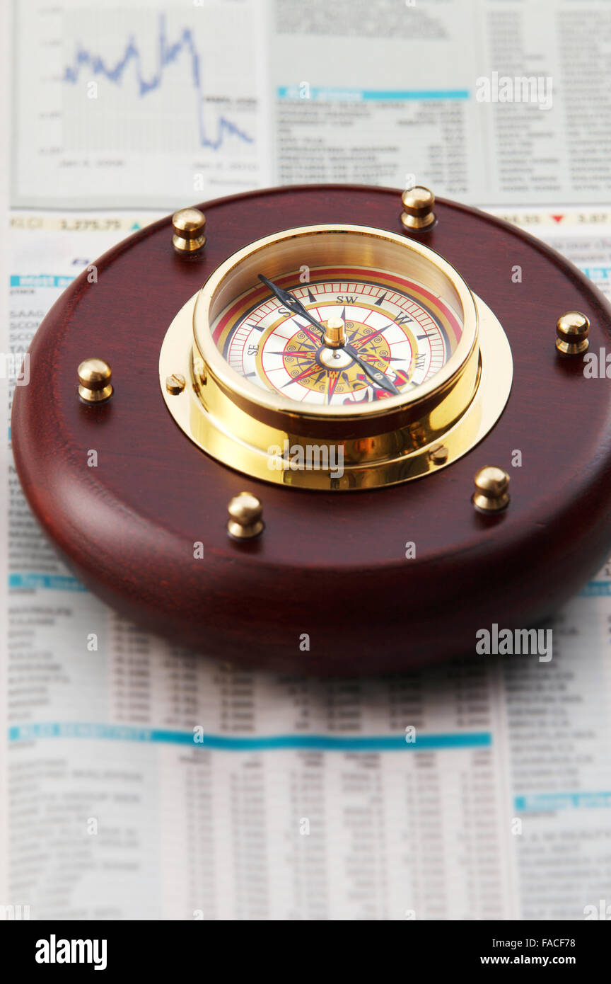 Compass on list of share prices Stock Photo - Alamy