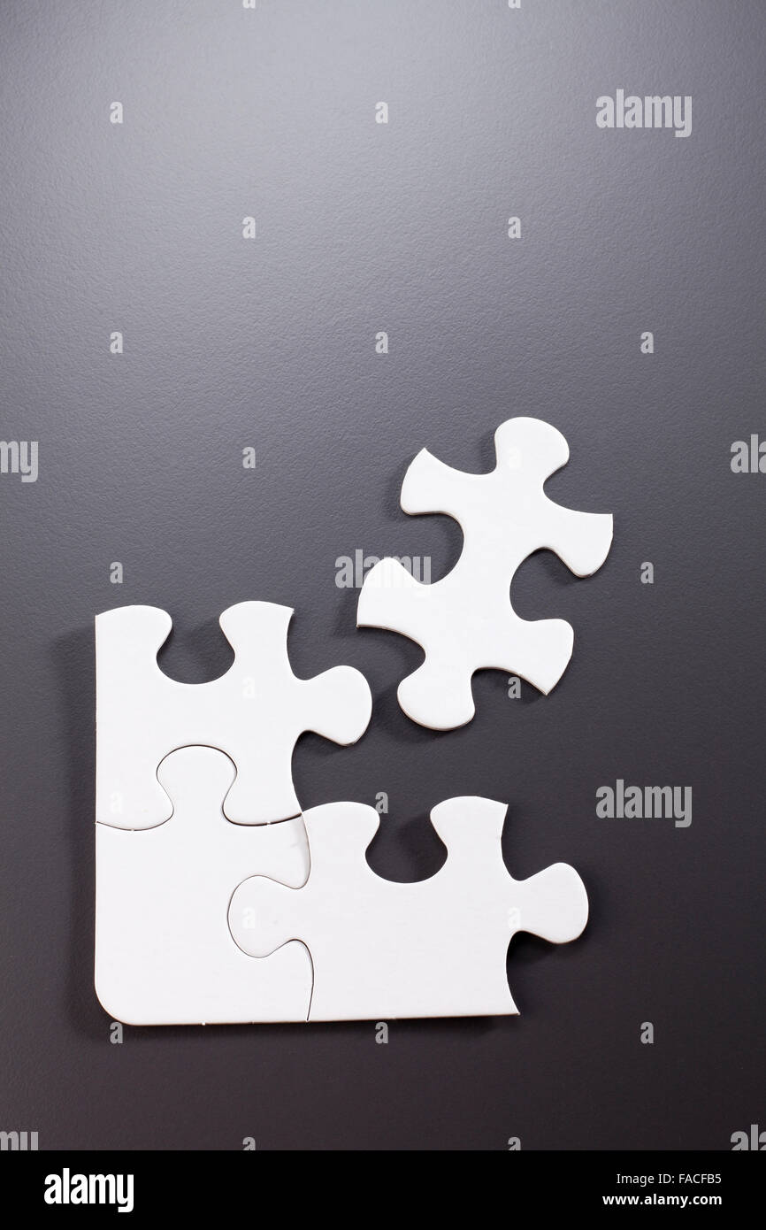 Puzzle pieces fitting together to form a team Stock Photo - Alamy
