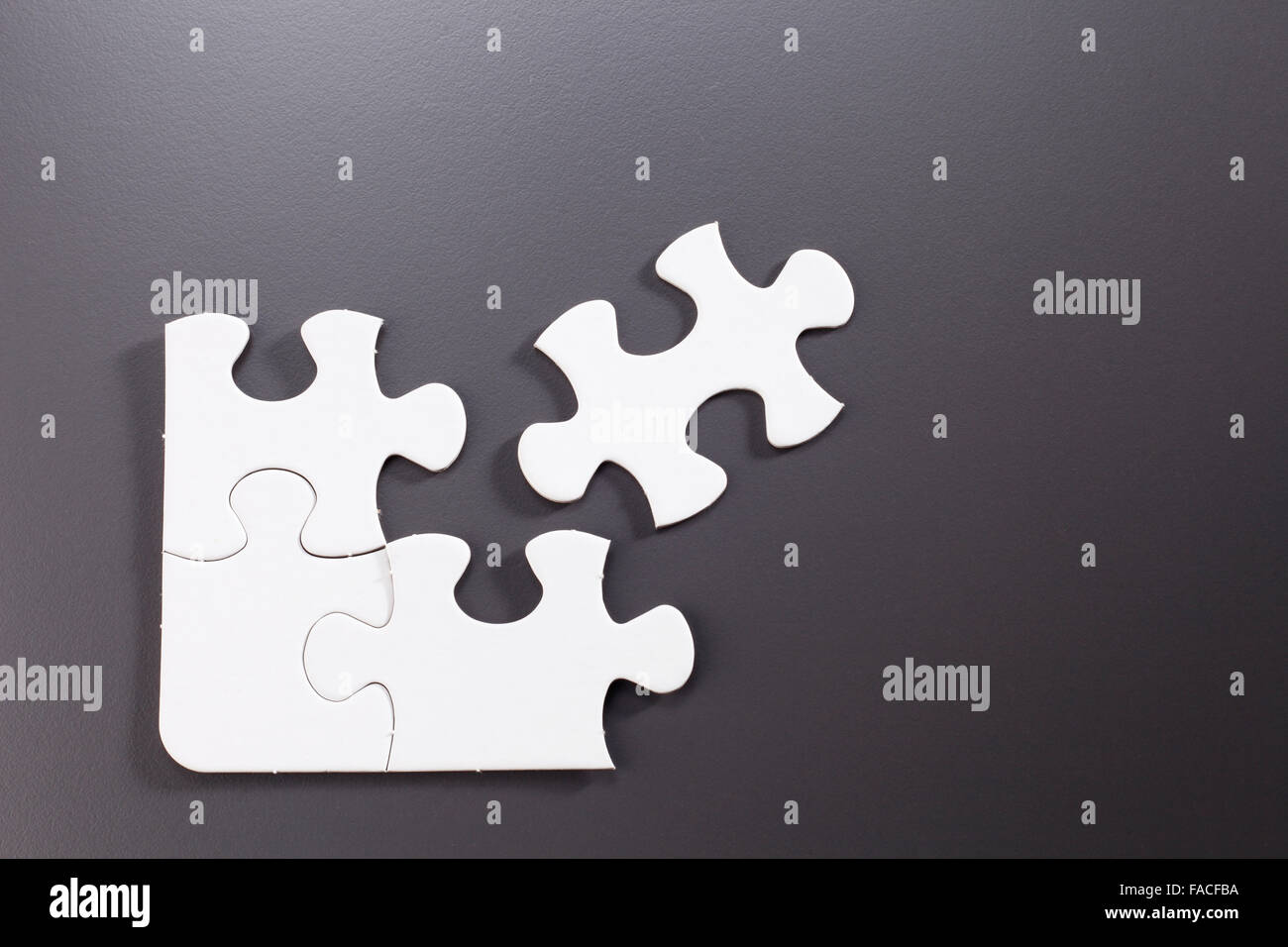 Puzzle pieces fitting together to form a team Stock Photo - Alamy