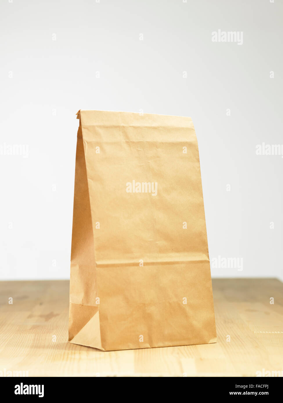 folded paper bag on the table Stock Photo - Alamy