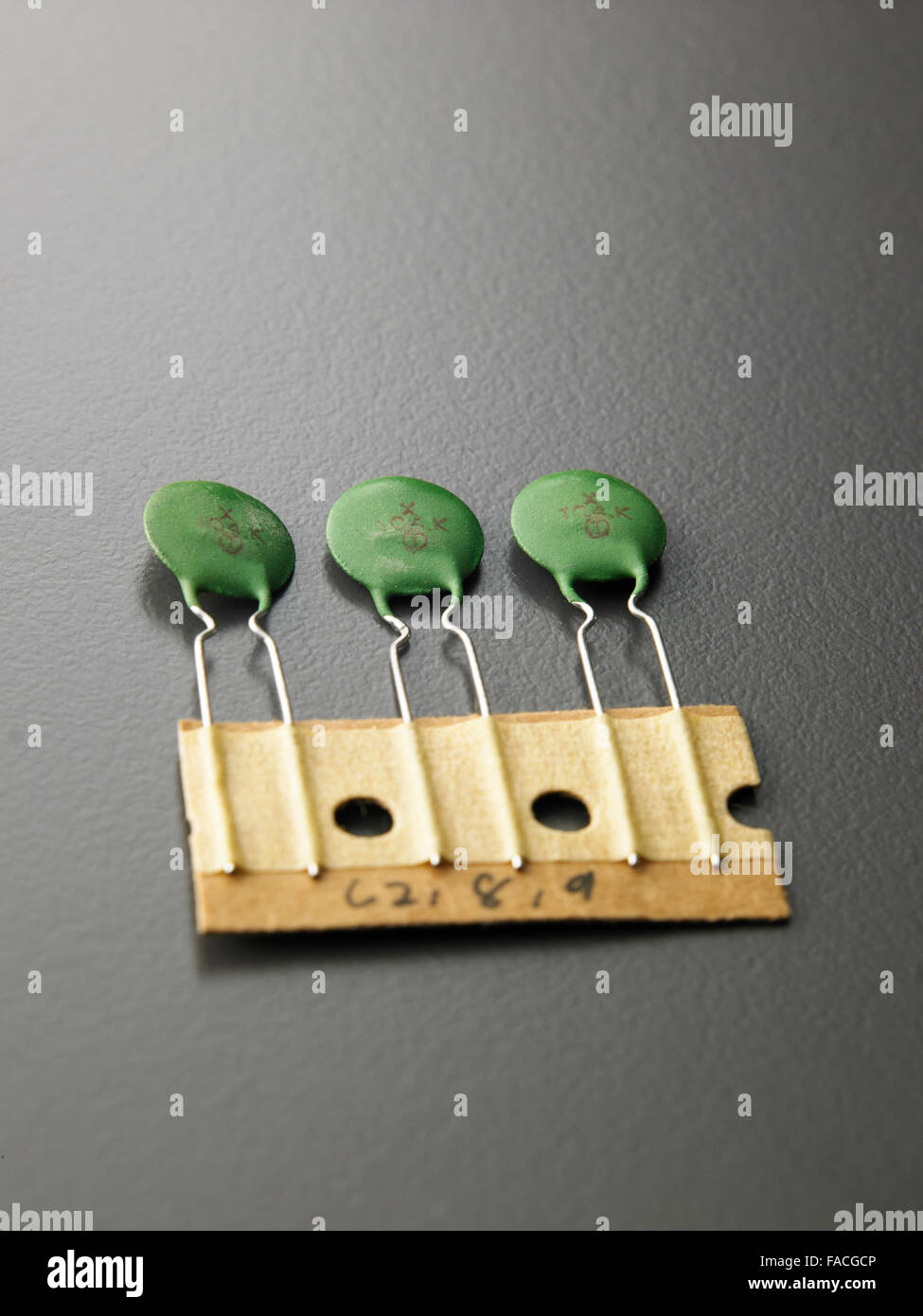 Ceramic disc capacitor on the gray background Stock Photo - Alamy