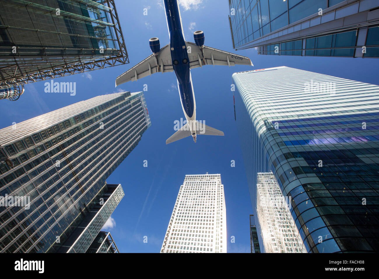 Banks in Canary Wharf, London, UK with a plane flying over Stock Photo ...