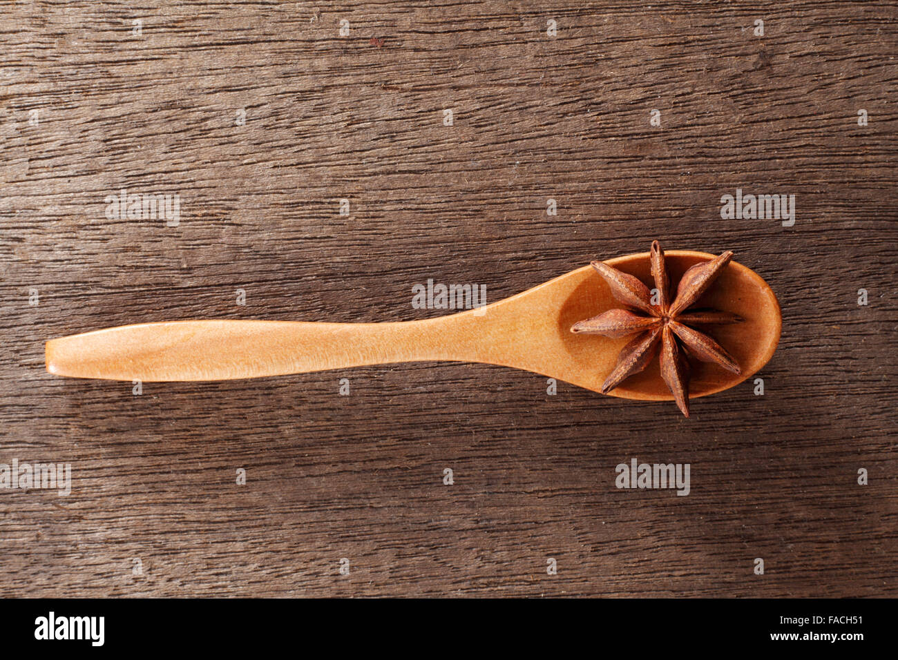 wooden spoon and anise star Stock Photo - Alamy