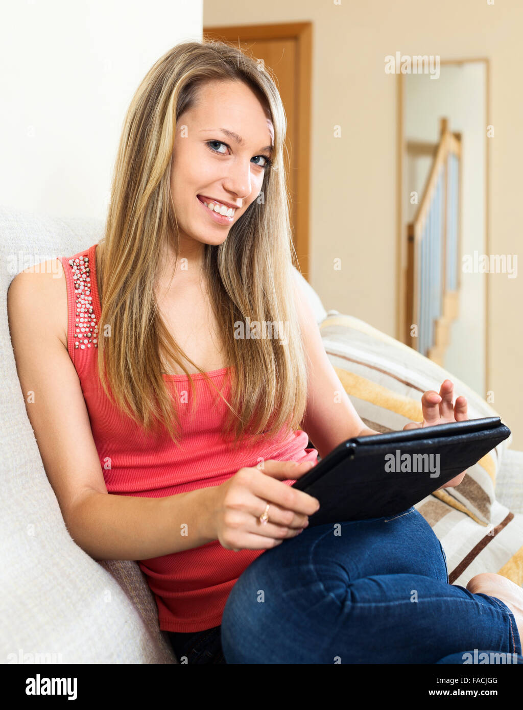 young woman using touchscreen at tablet in home Stock Photo - Alamy